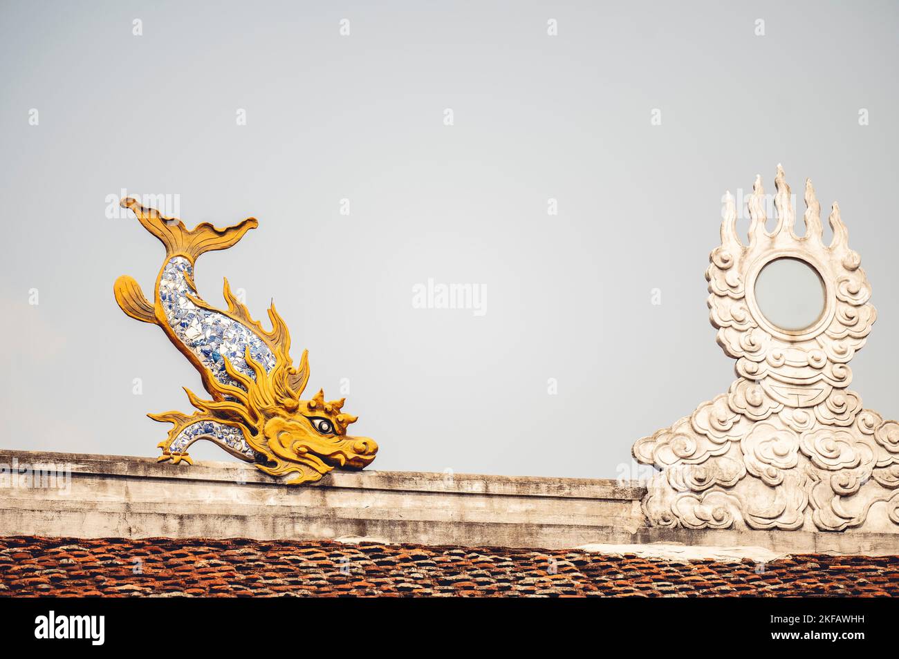 A scenic view of an Asian dragon symbol seen on top of a building in ...