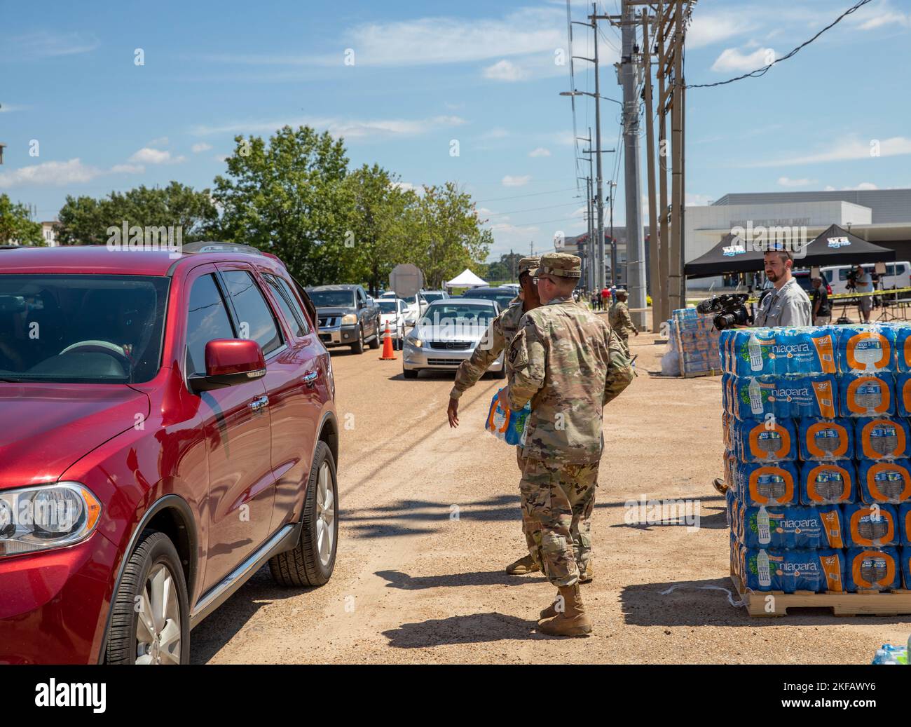 A Mississippi National Guard Soldier takes water to a person's car at ...