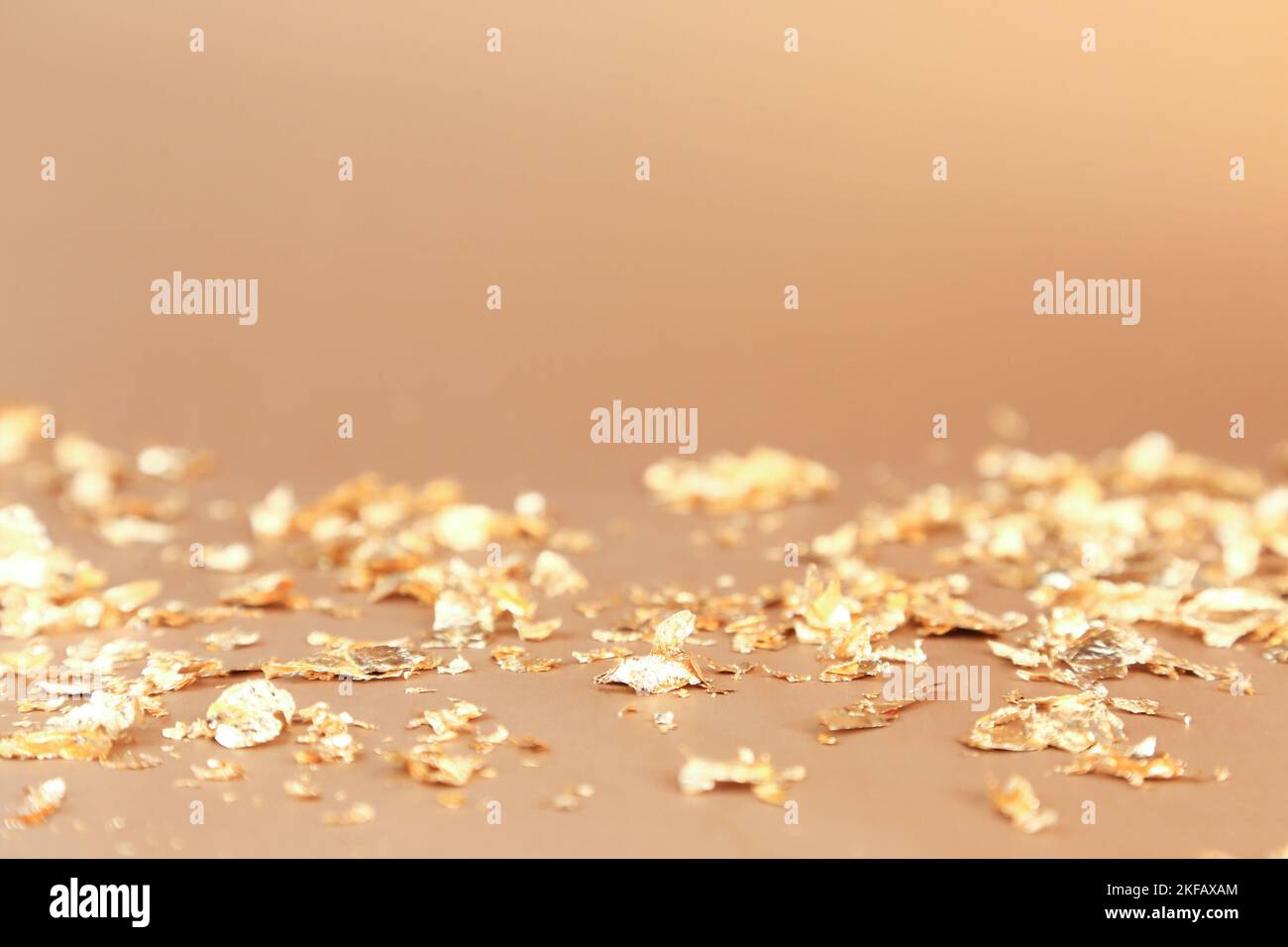Cosmetics product advertising backdrop. Pieces of gold paper ...