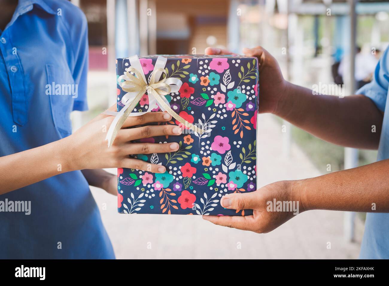 Students in uniform hand each other presents on Christmas and New Year ...