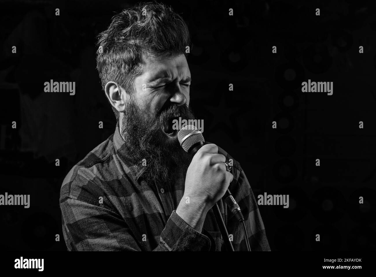 Talent show concept. Man with tense face holds microphone Stock Photo ...