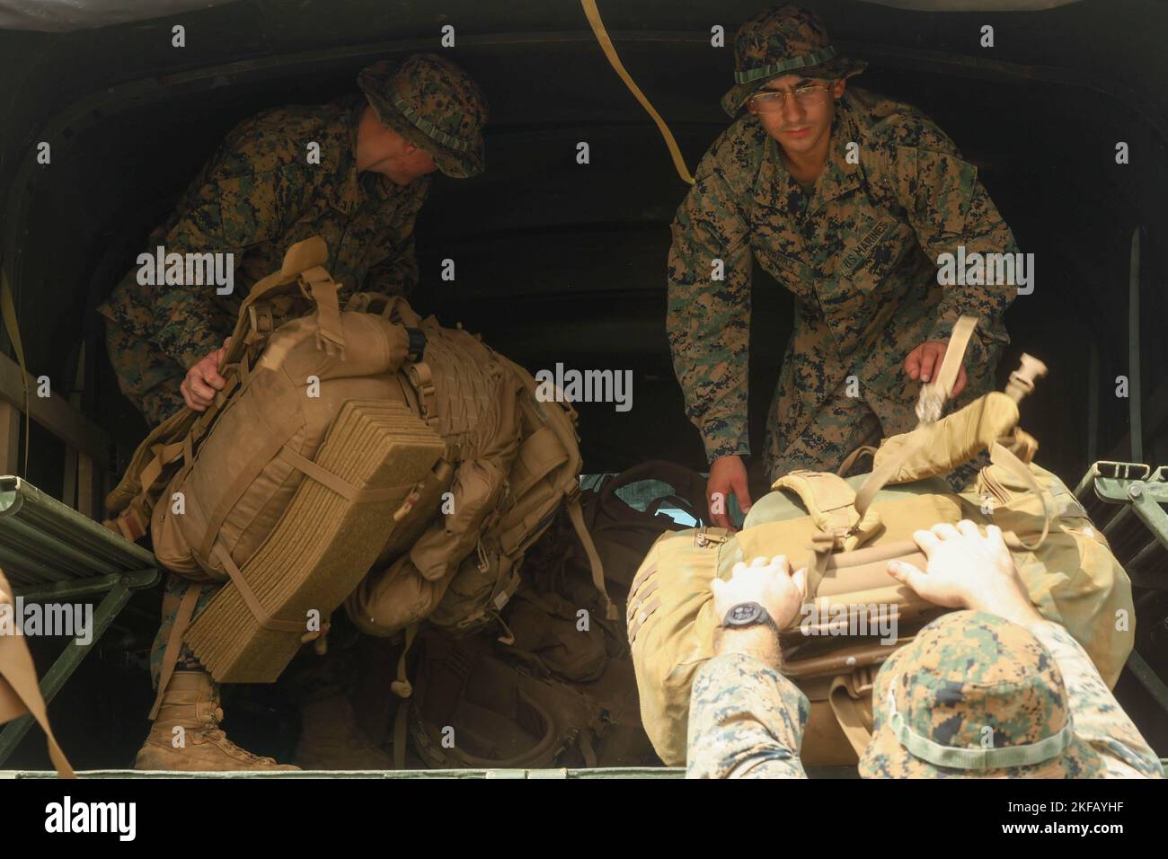 U.S. Marines with 3d Marine Division load their gear into a Medium ...