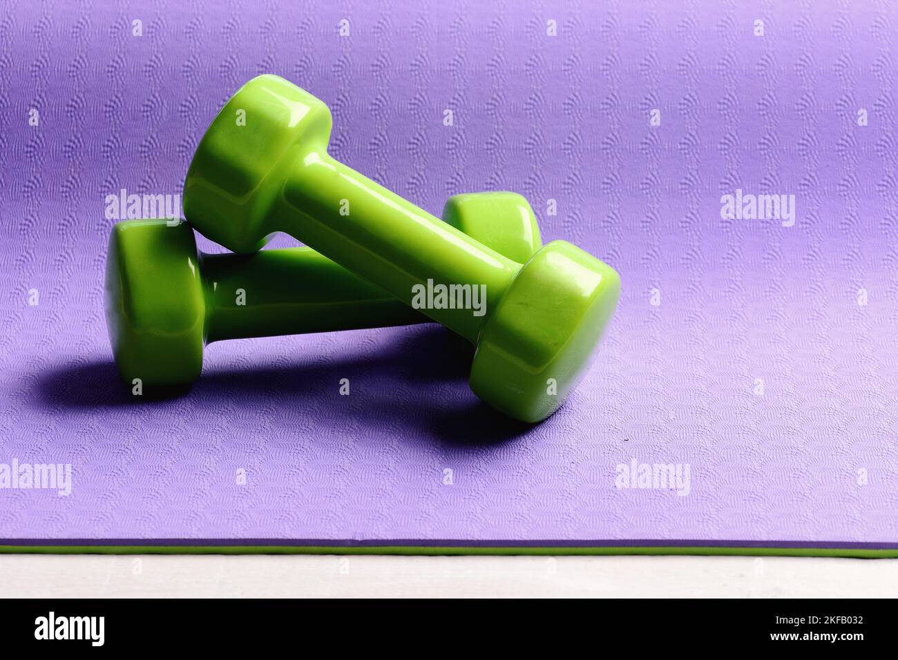 Shaping and fitness equipment. Dumbbells made of green plastic Stock ...