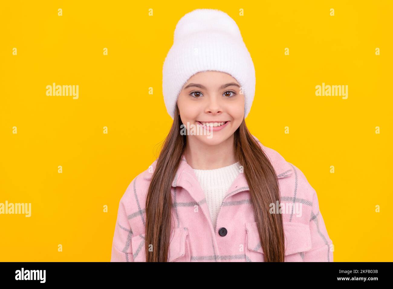 winter fashion. happy kid in hat. female fashion model on yellow ...