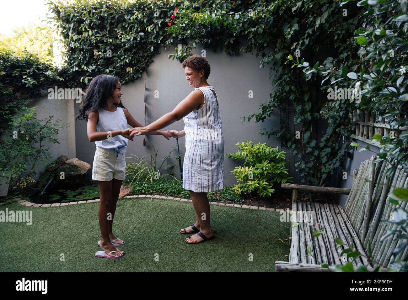 Granny and kid dancing together outdoors. Grandmother and girl ...