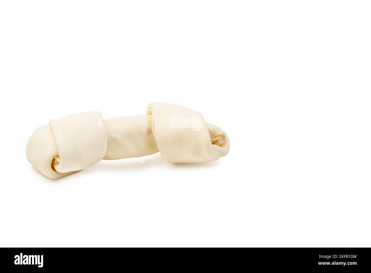 Rawhide bone on a white background with copy space Stock Photo - Alamy