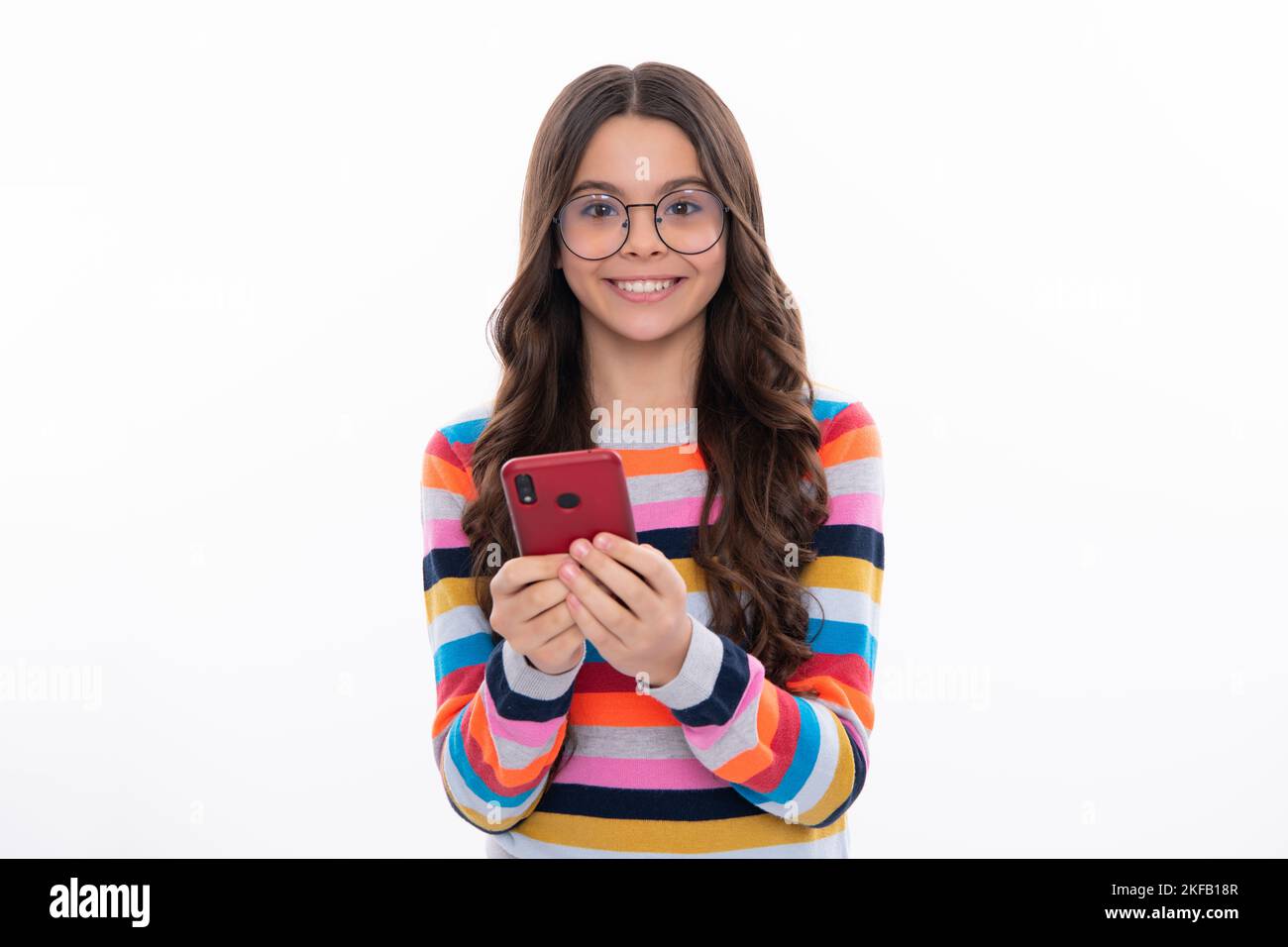 Mobile online shopping. Cute teen child girl paying with phone, texting ...