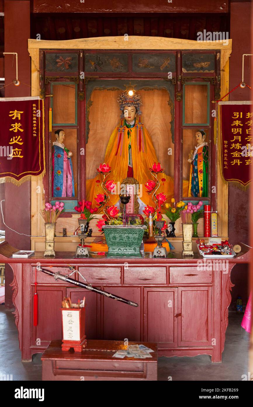 Altar shrine with Taoist imagery and deity in a temple building ...