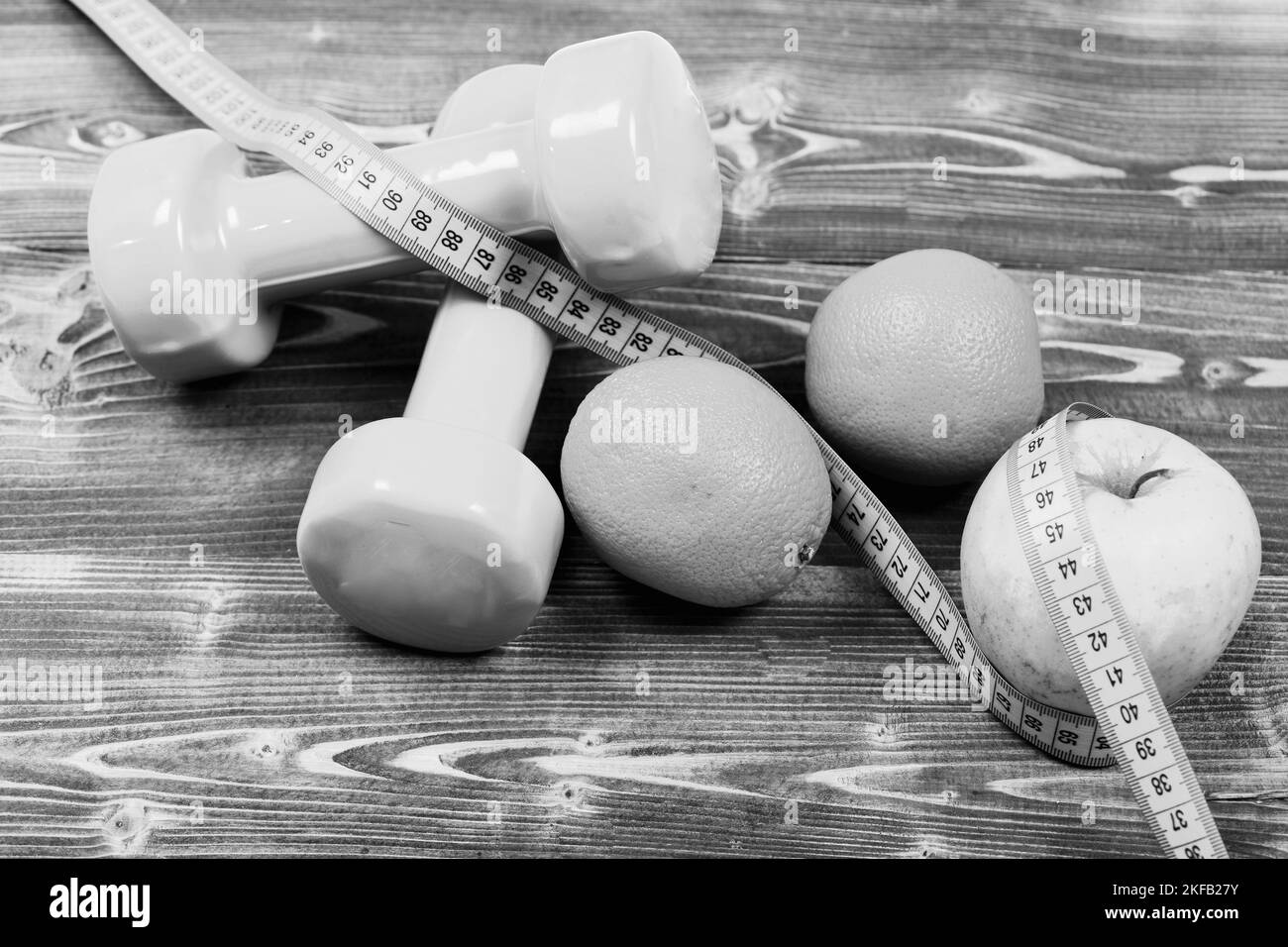 centimeter with dumbbells weight and apple, orange - diet concept Stock ...