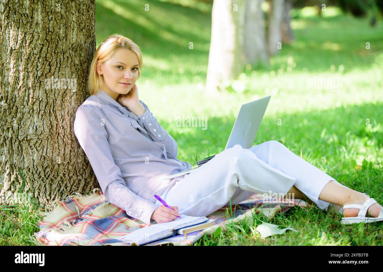 Work outdoors benefits. Woman with laptop computer work outdoors lean ...