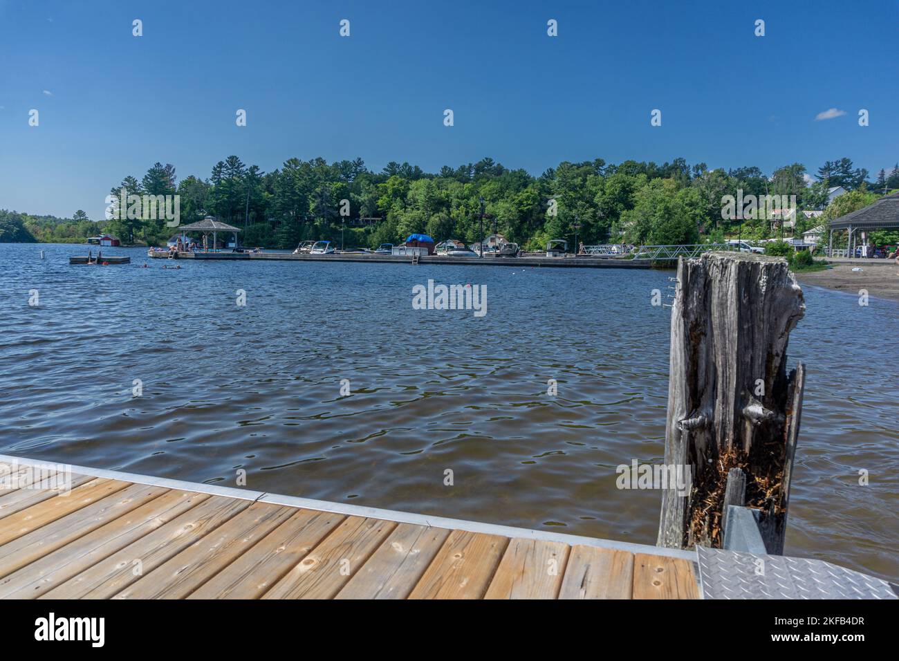 Wooden jetty and cleat on Lake Rosseau, Muskoka, Ontario, Canada. A ...
