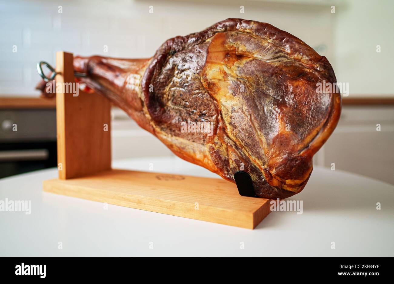 Dry-cured spanish ham. Jamon on a wooden stand Stock Photo - Alamy