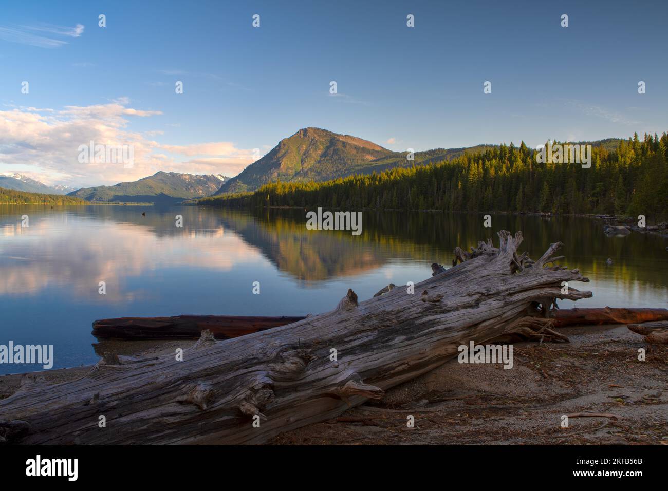 Early morning light bathes Lake Wenatchee in sunshine, on a calm, quiet ...