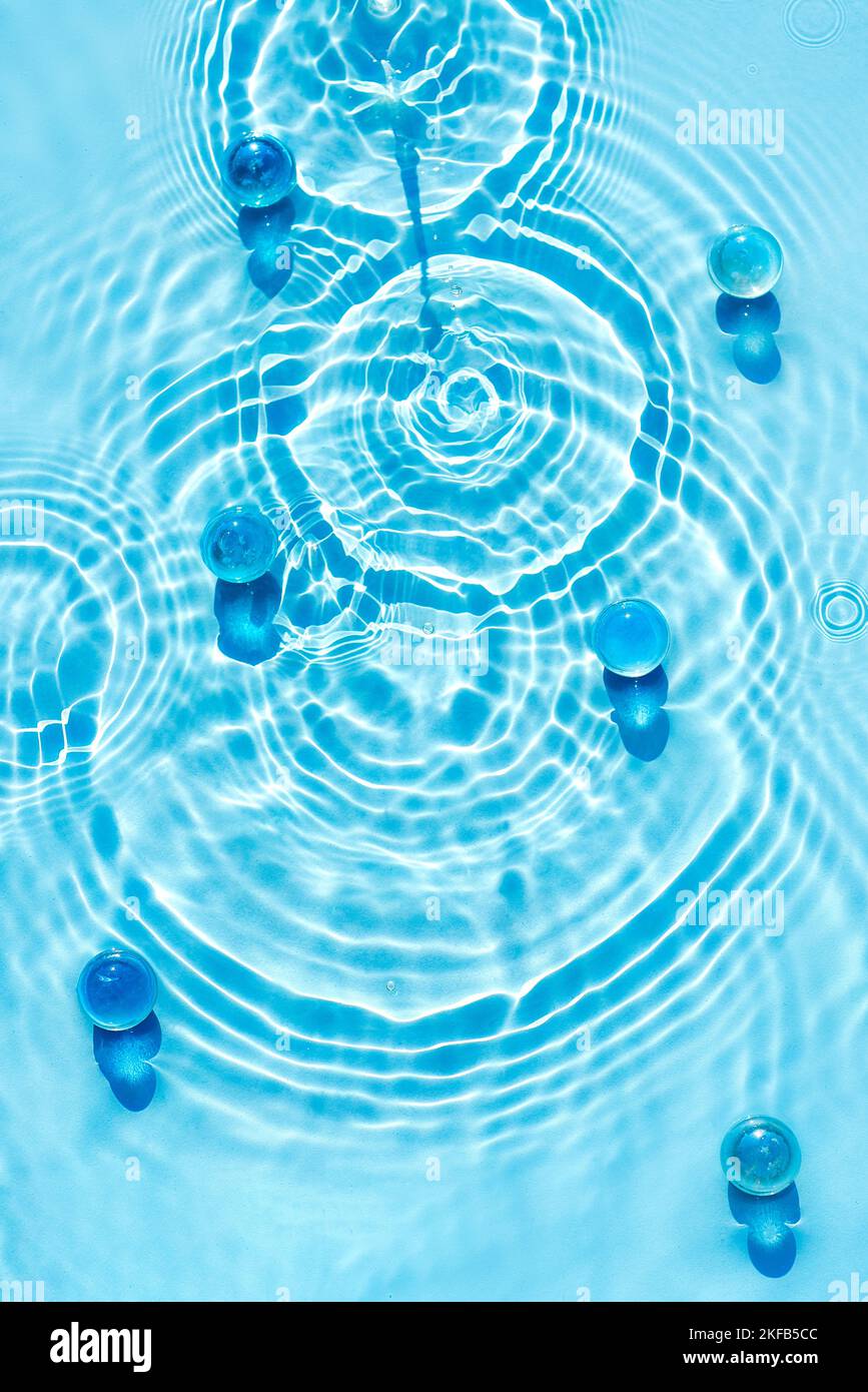 Clear water surface texture in transparent blue color with ripples ...