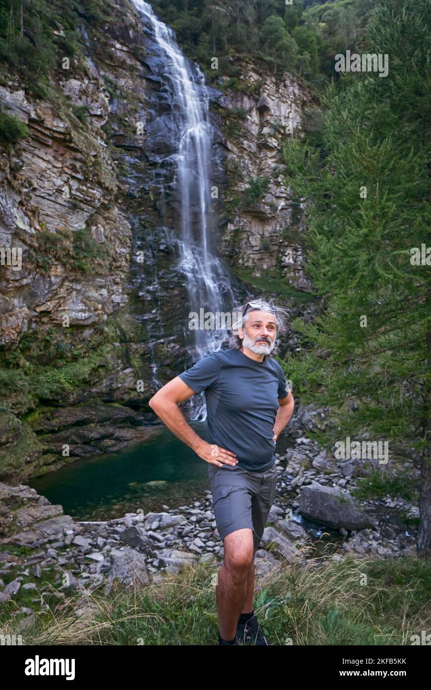 man under the Froda Waterfall in Sonogno, Switzerland Stock Photo - Alamy