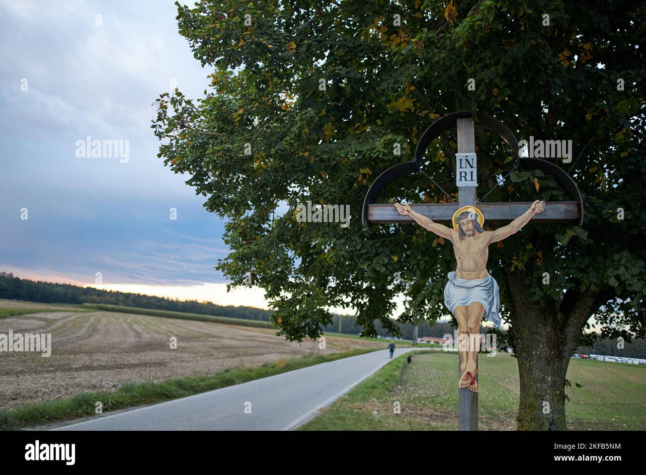 The wooden cross with the picture of Jesus Christ in a rural area Stock ...