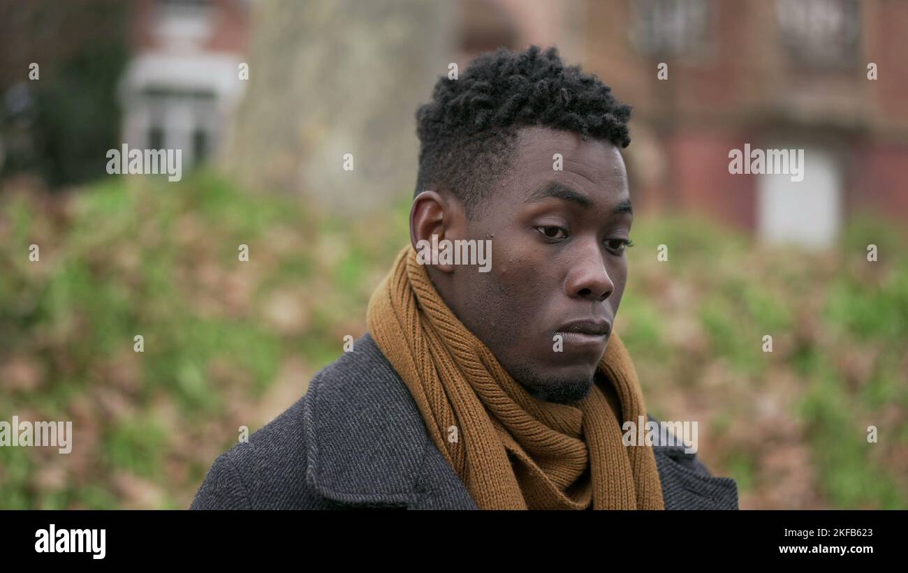 Doubtful young black man thinking about life Stock Photo - Alamy
