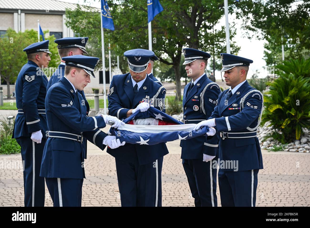 U.S. Air Force base honor guard members fold the American flag during a retreat ceremony at ...