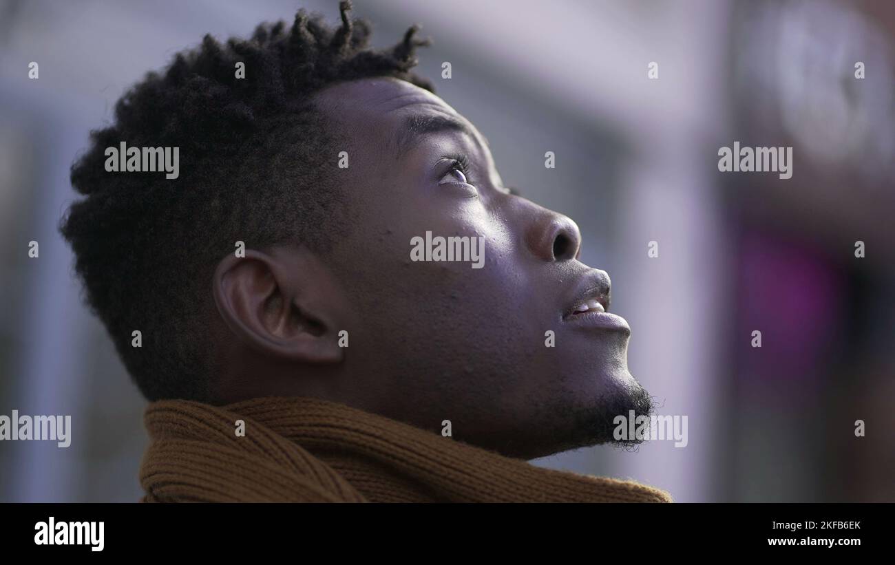 Contemplative African young man face looking up at the sky Stock Photo ...