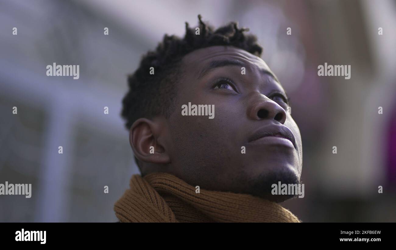 Contemplative African young man face looking up at the sky Stock Photo ...