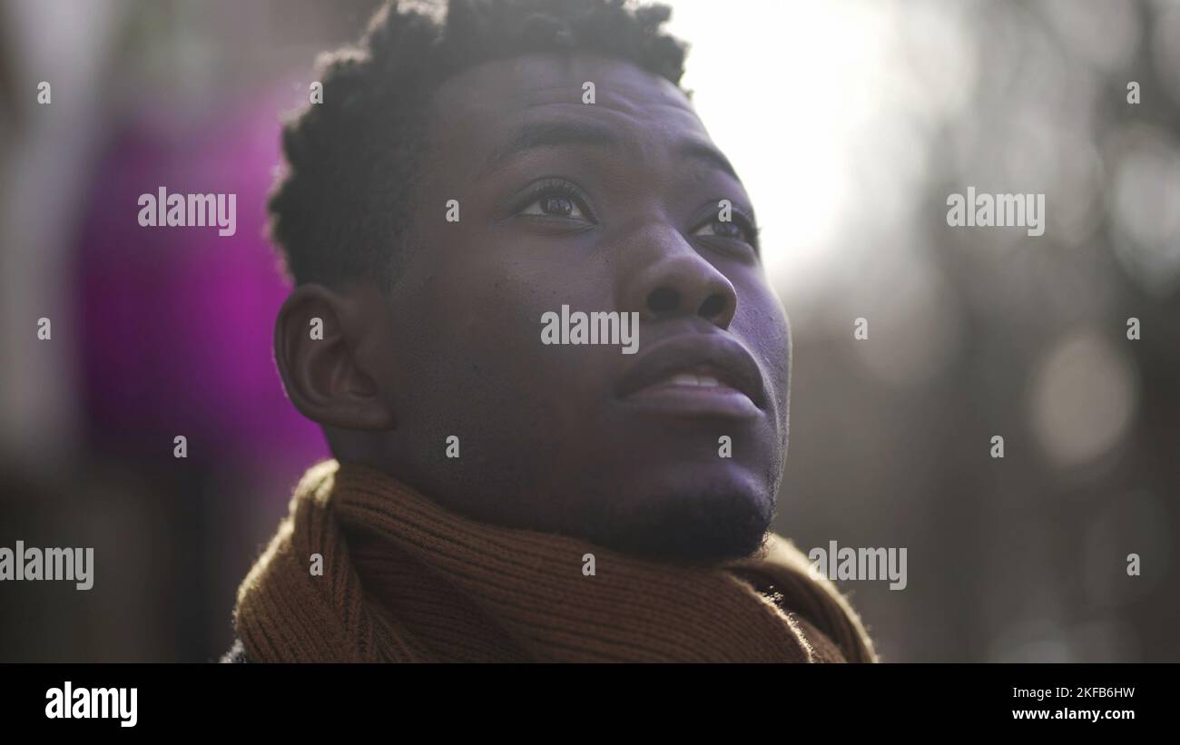Contemplative African young man face looking up at the sky Stock Photo ...