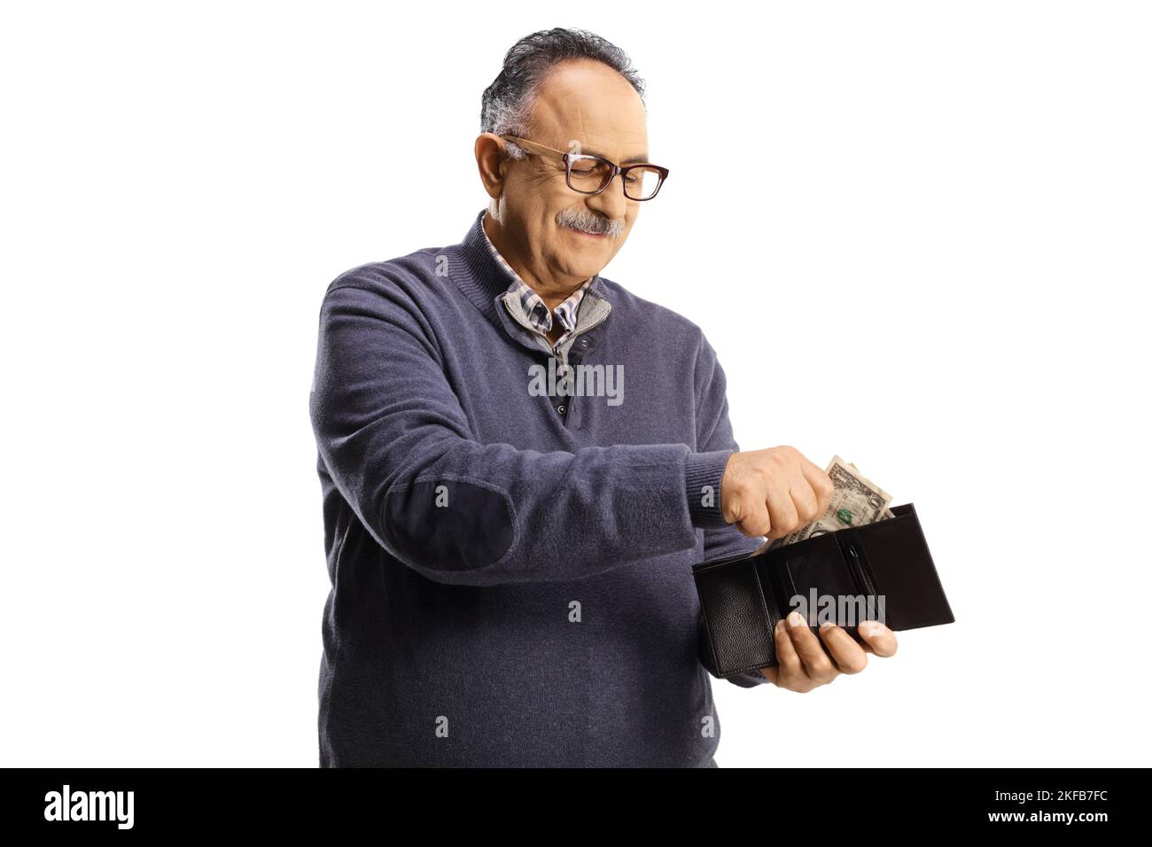 Mature man smiling and putting money in a wallet isolated on white ...
