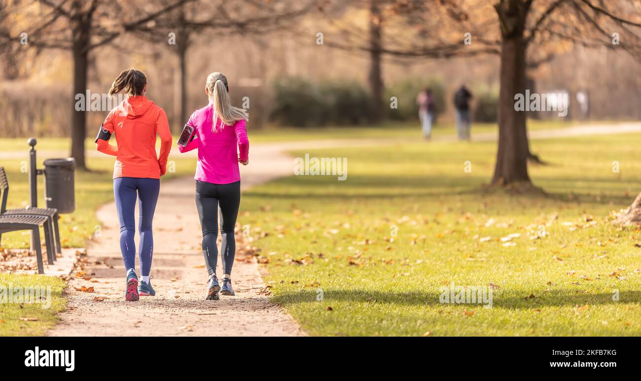 Back view two women running hi-res stock photography and images - Alamy