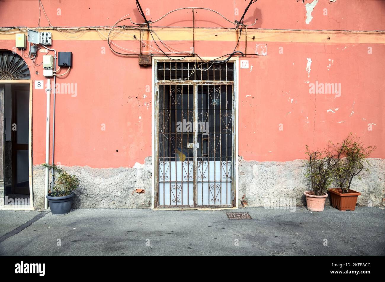 Front door of a building closed by a gate Stock Photo - Alamy