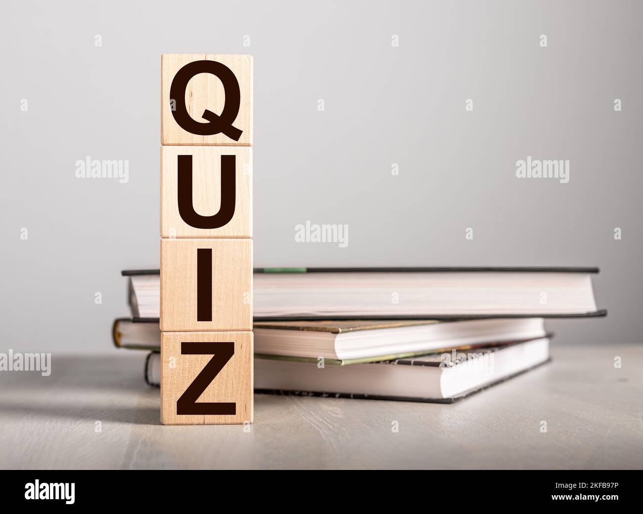 Quiz letters on wood blocks and books for school education. Quizz, test ...