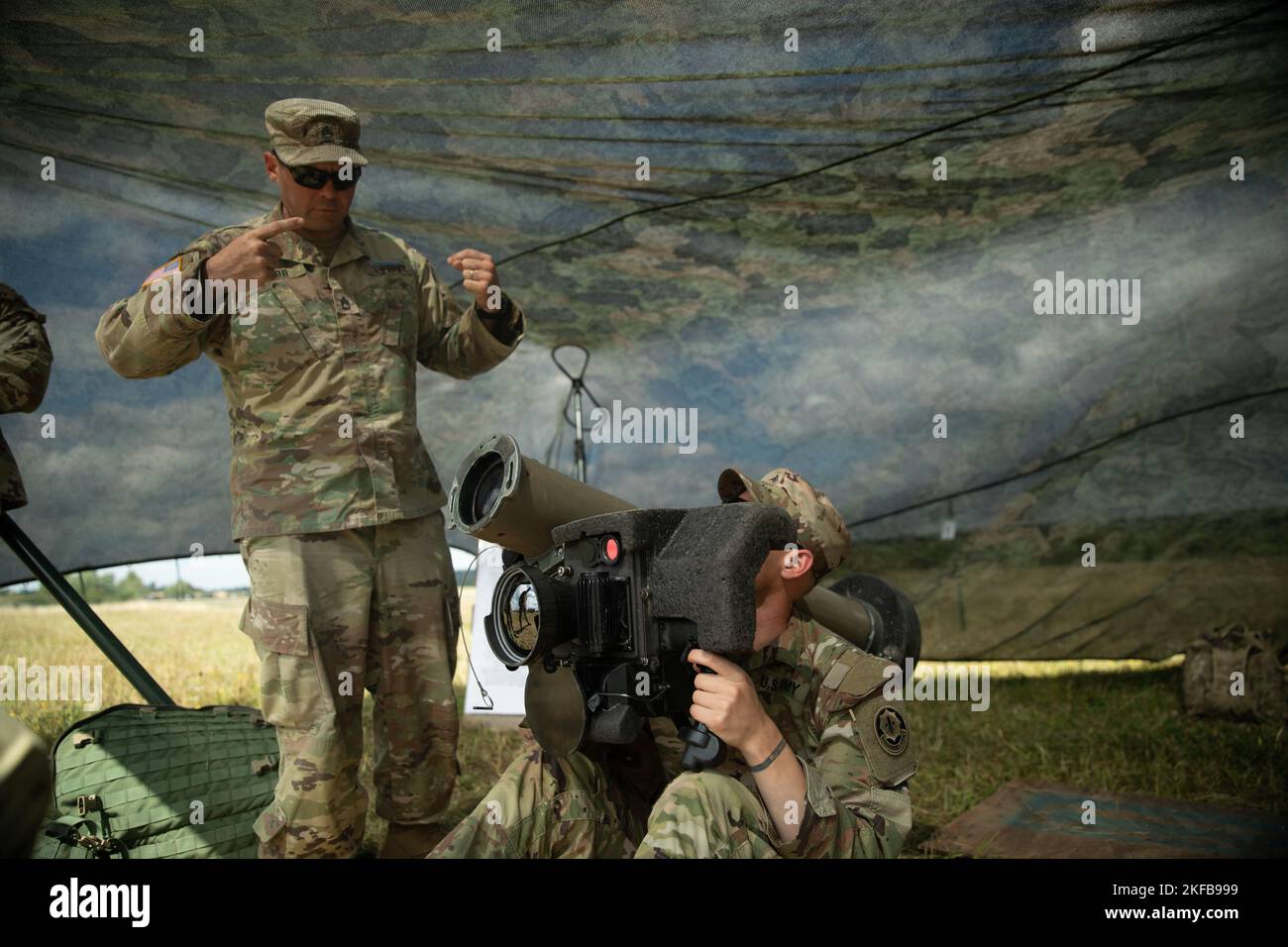 A U.S. Soldier receives guidance on how to successfully operate a FMG ...