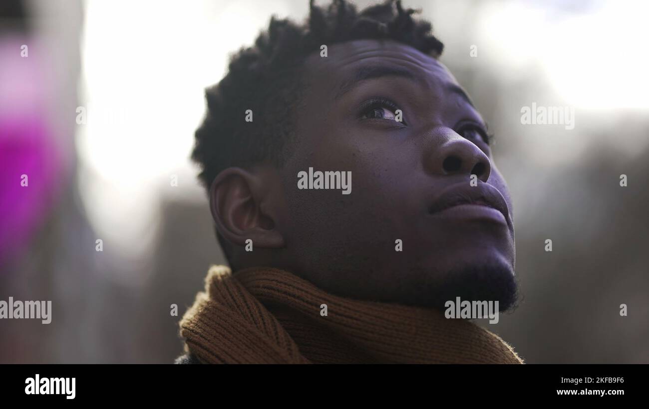 Contemplative African young man face looking up at the sky Stock Photo ...