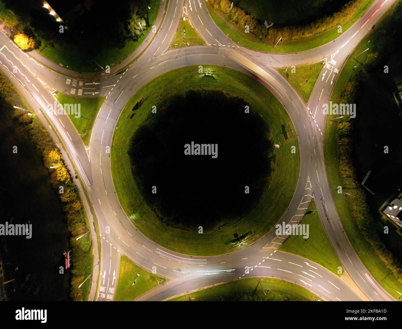 A bird's eye view of traffic on a glowing roundabout at night Stock ...
