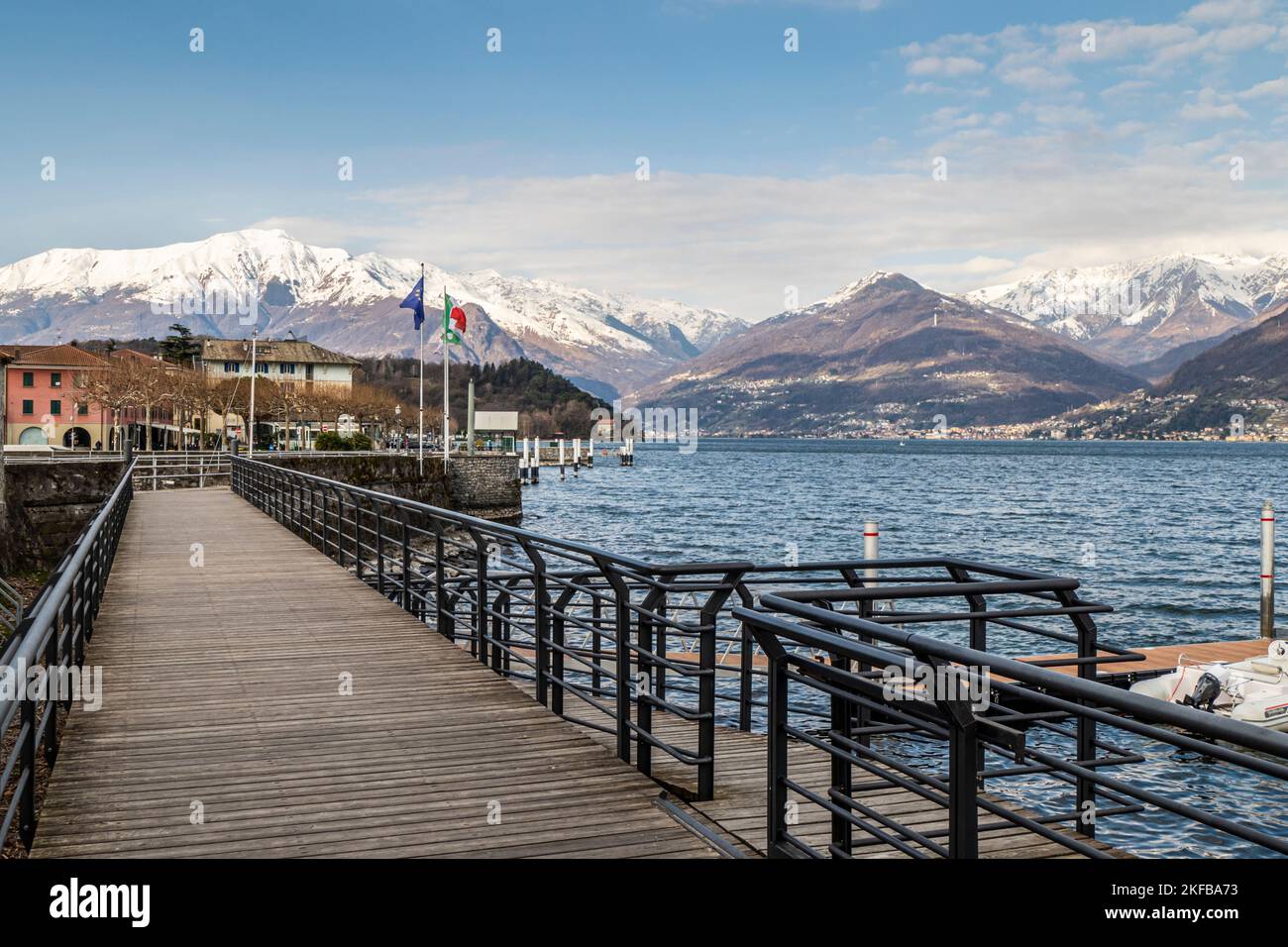 The lakeside promenade of Colico with the snow-capped Alps in the ...