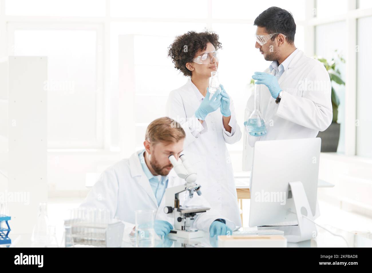 staff of the scientific medical laboratory congratulating each other on ...