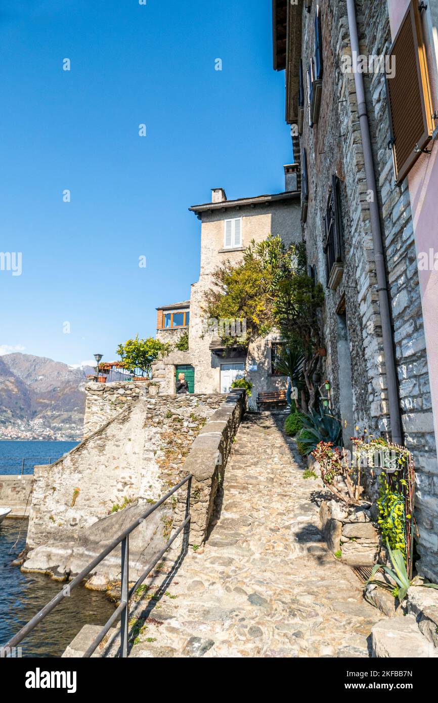 Corenno Plinio with stone houses, plants and flowers Stock Photo - Alamy