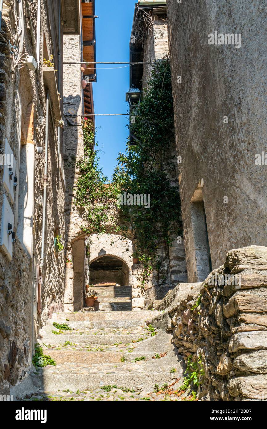 The interior of Corenno Plinio with narrow stone streets, arches and ...