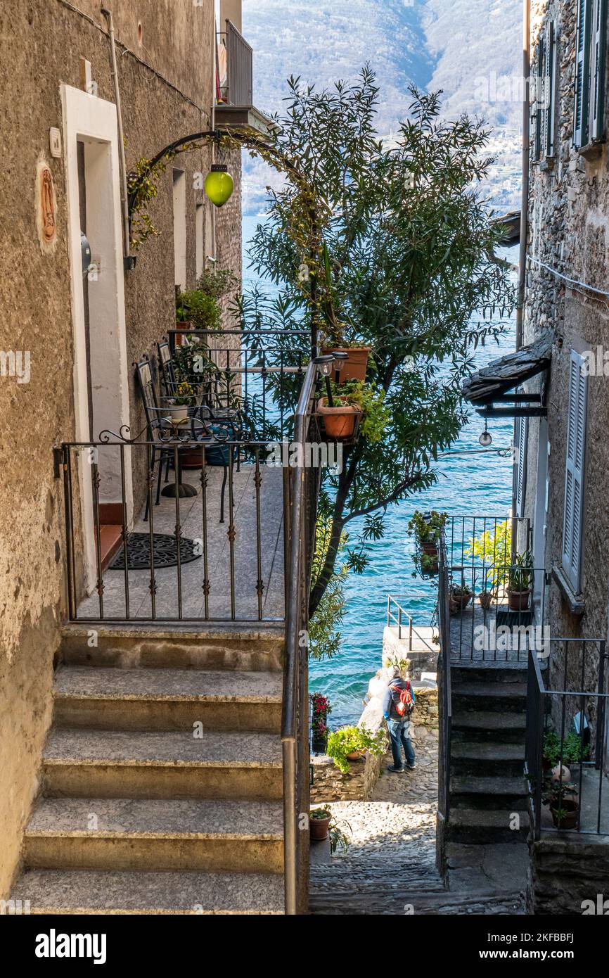 Corenno Plinio with stone houses, plants and flowers Stock Photo - Alamy