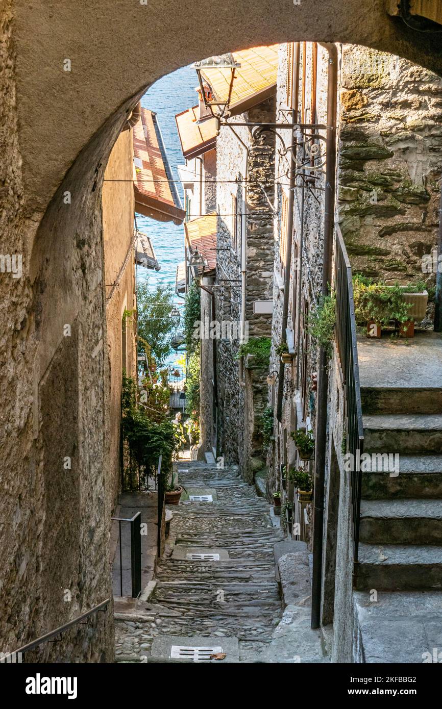 The interior of Corenno Plinio with narrow stone streets, arches and ...