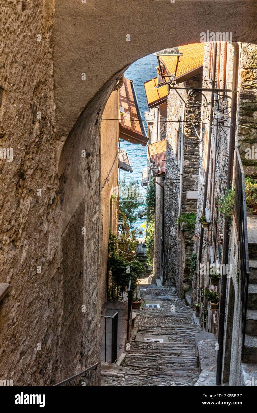 The interior of Corenno Plinio with narrow stone streets, arches and ...