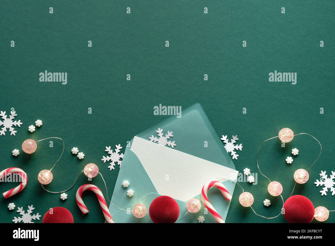 Greeting card in paper envelope. Christmas background on green paper ...