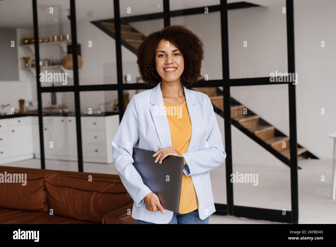 Confident african woman realtor with laptop showing apartments for rent ...