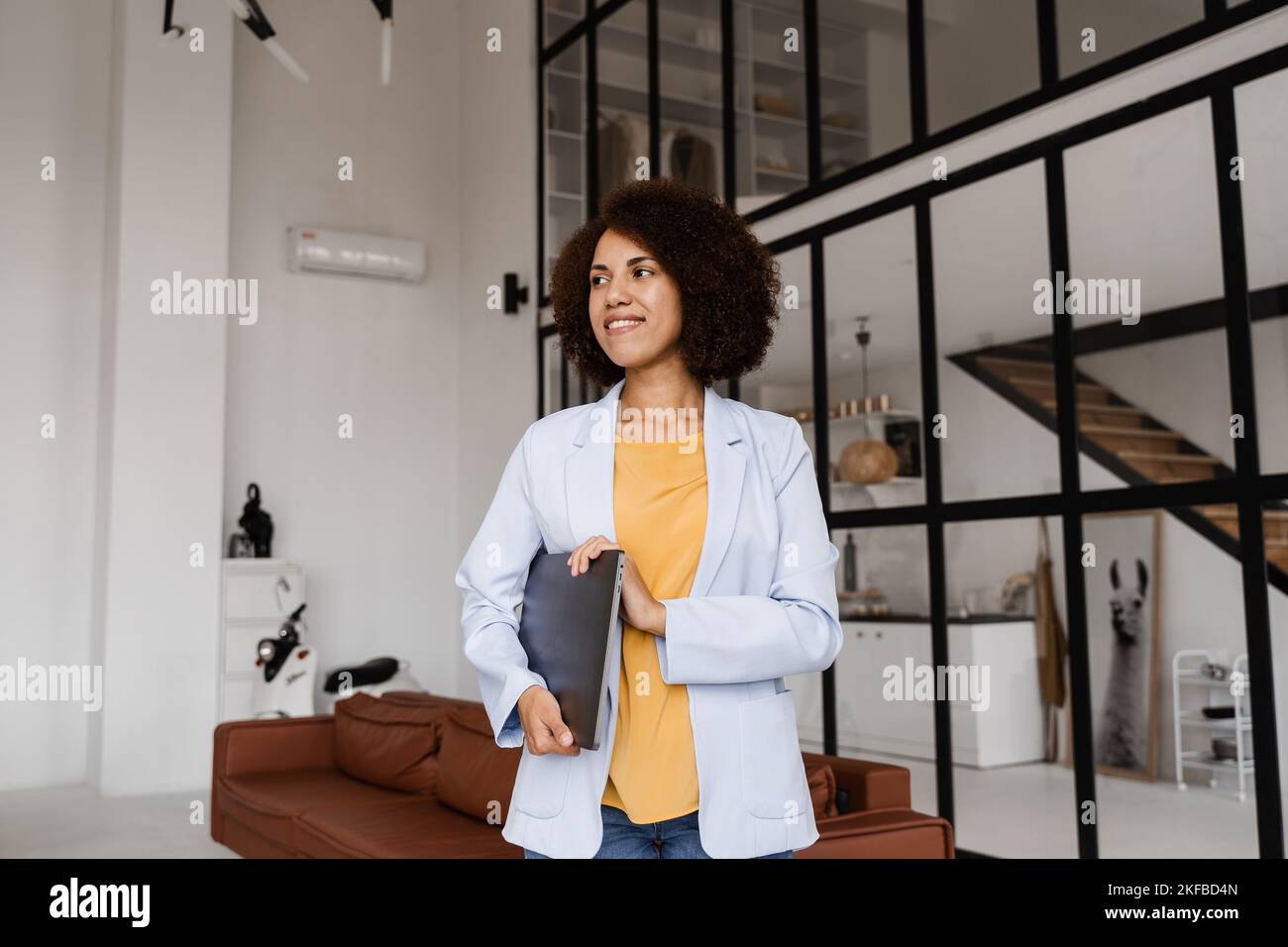 Confident african woman realtor with laptop showing apartments for rent ...