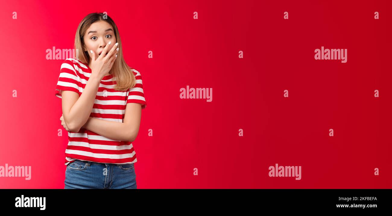 Shocked asian blond girl feel empathy hear shocking news gasping, woman ...