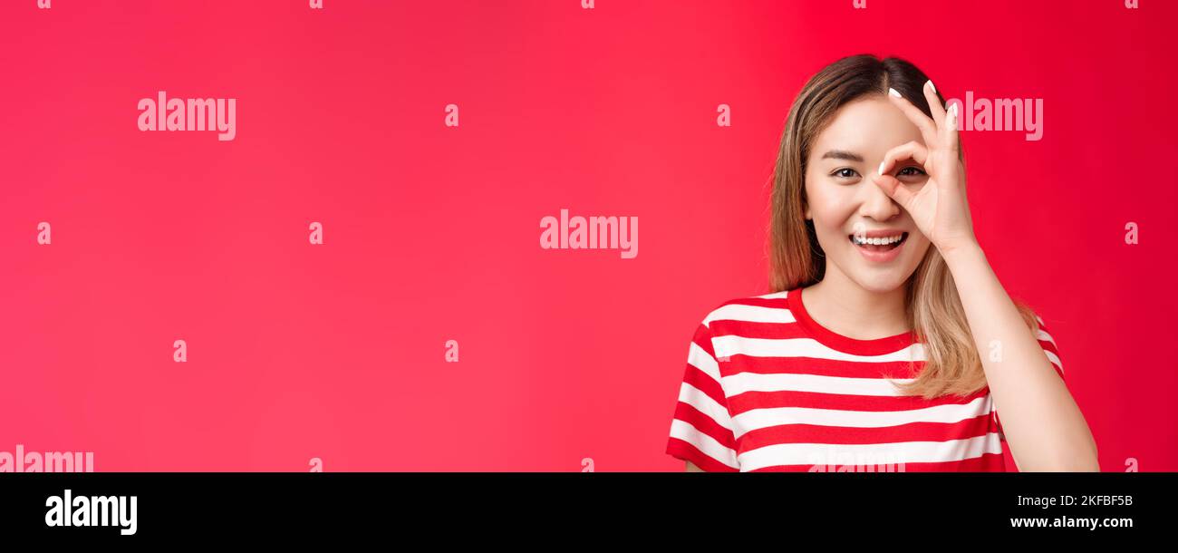 Close-up upbeat positive asian girl look through ok sign smiling ...