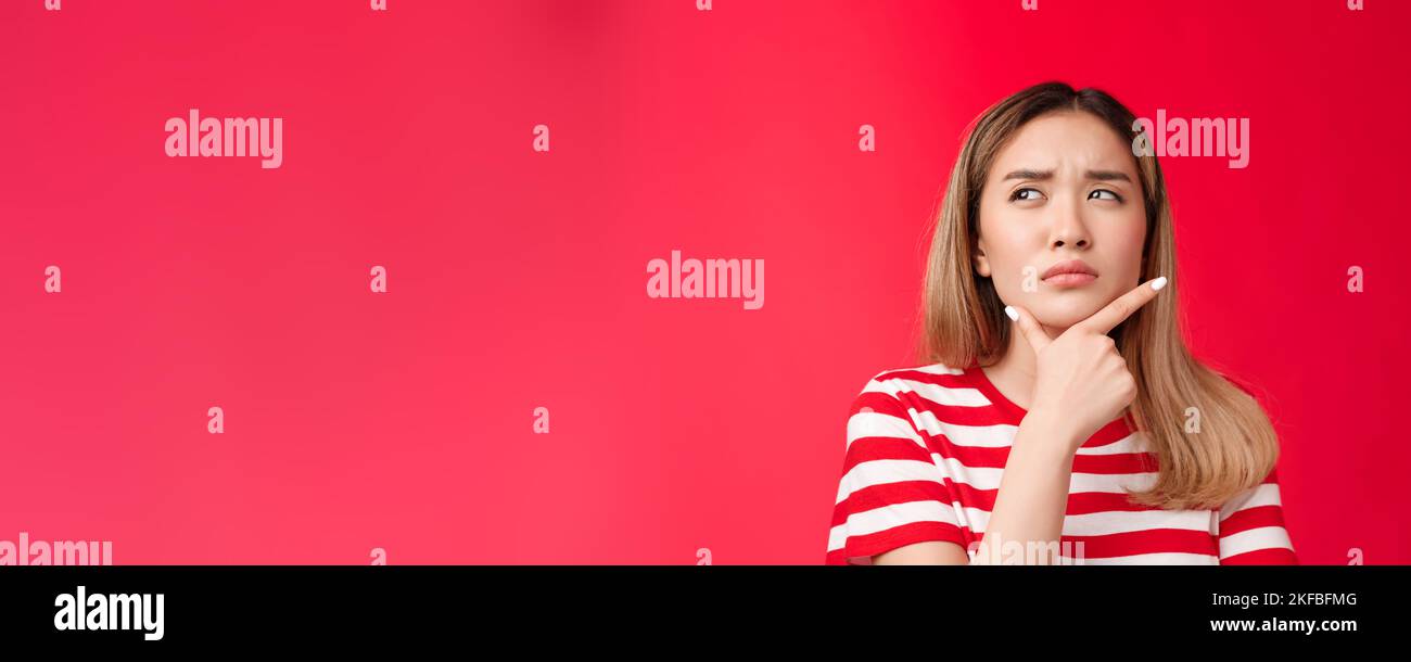 Close-up suspicious thoughtful girlfriend pondering, touch chin ...