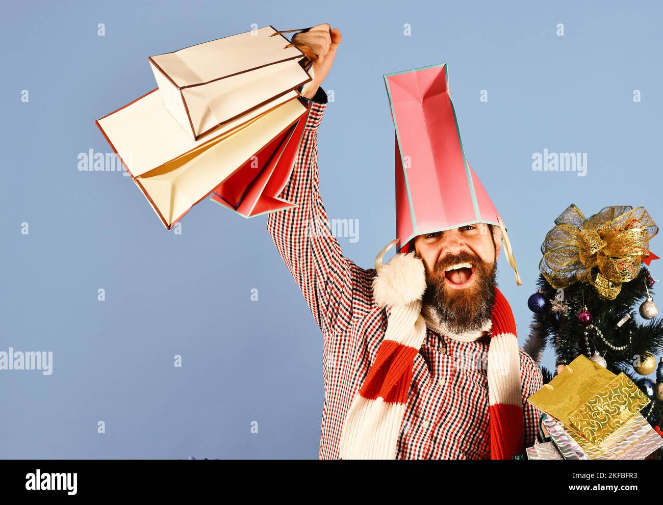 Hipster with pink packet on head holds shopping bags Stock Photo - Alamy