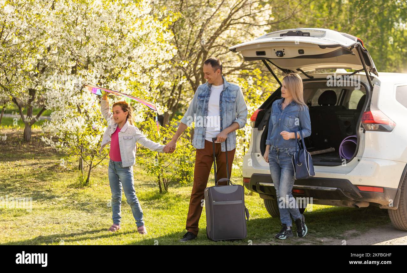 Travel car and camping luggage packed in the full car trunk. Outdoor ...