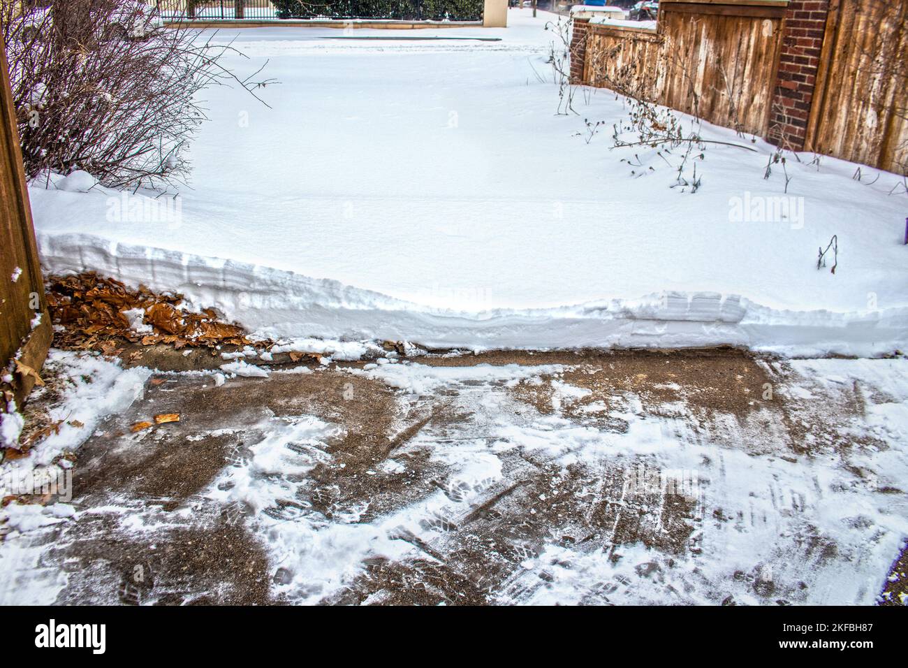 Driveway half shoveled of heavy snow with edge showing how deep it is ...