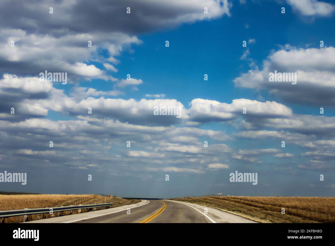 Driving on the rolling hills of Northeastern Oklahoma under a big blue ...