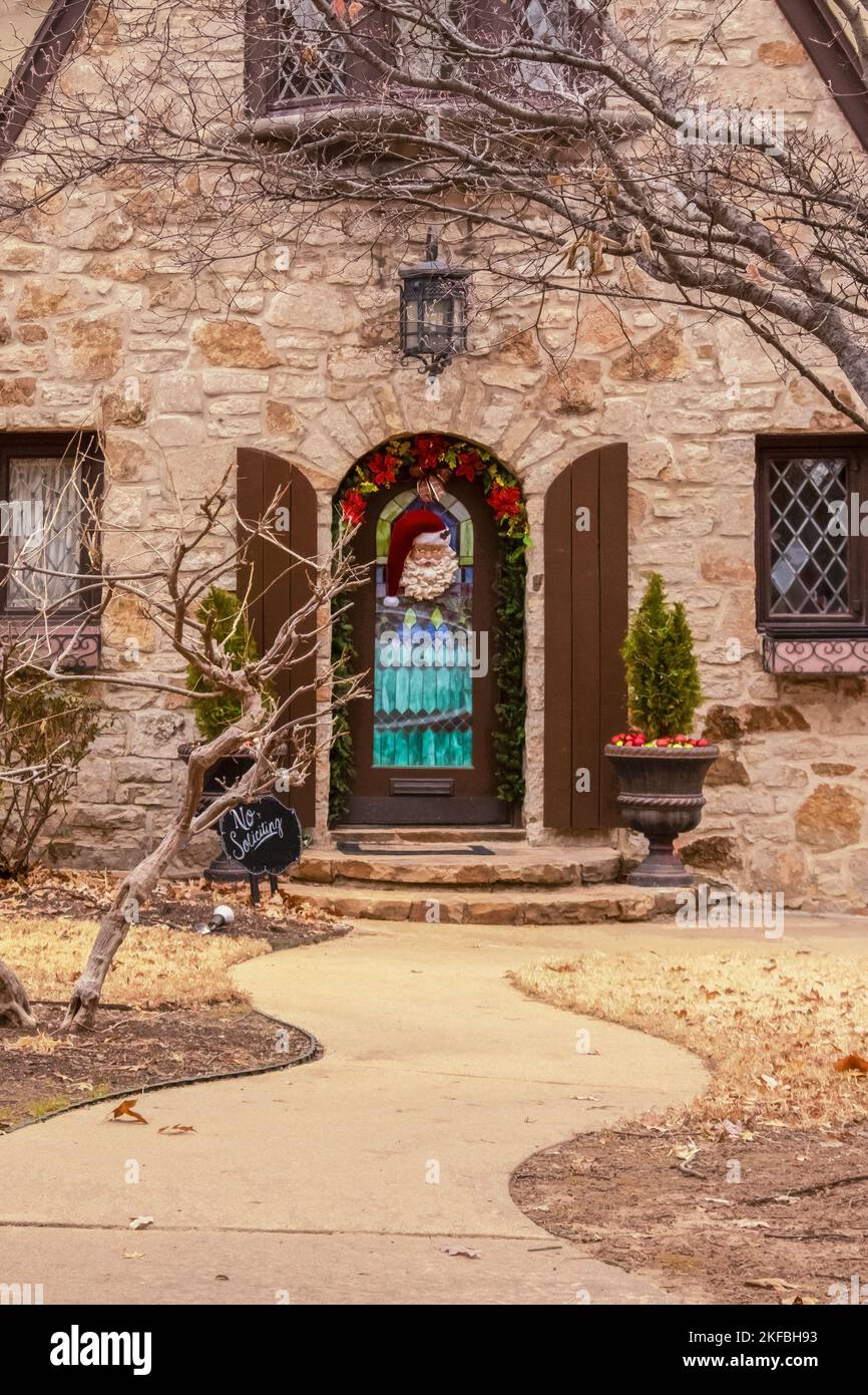 Entrance to rock house with pretty Christmas decorated front door and ...